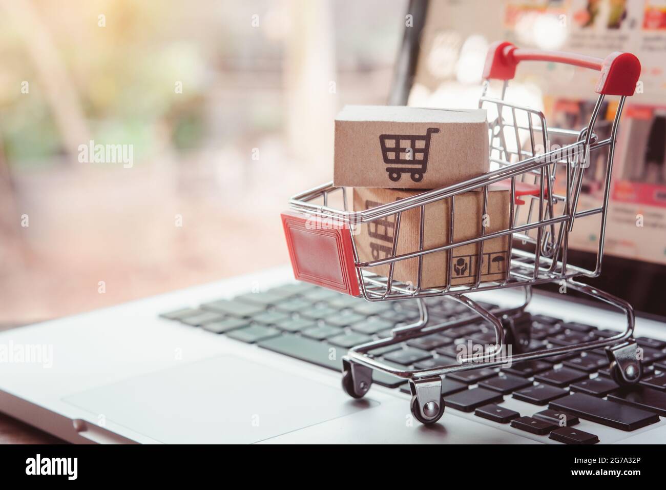 Shopping online. cardboard box with a shopping cart logo in a trolley ...