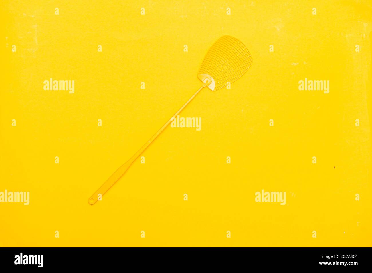 Yellow fly swatter isolated on yellow background Stock Photo - Alamy
