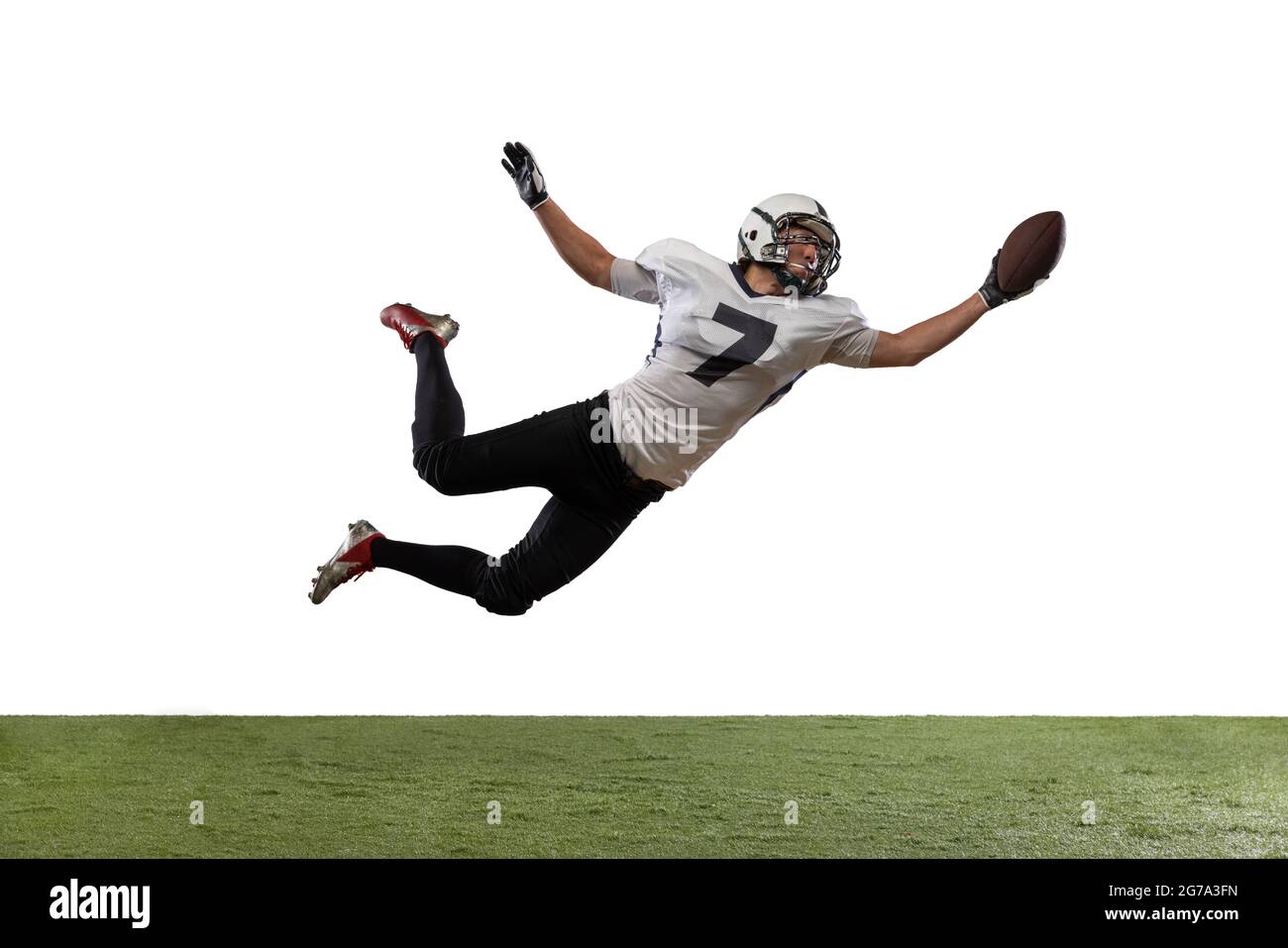Portrait of American football player catching ball in jump isolated on ...