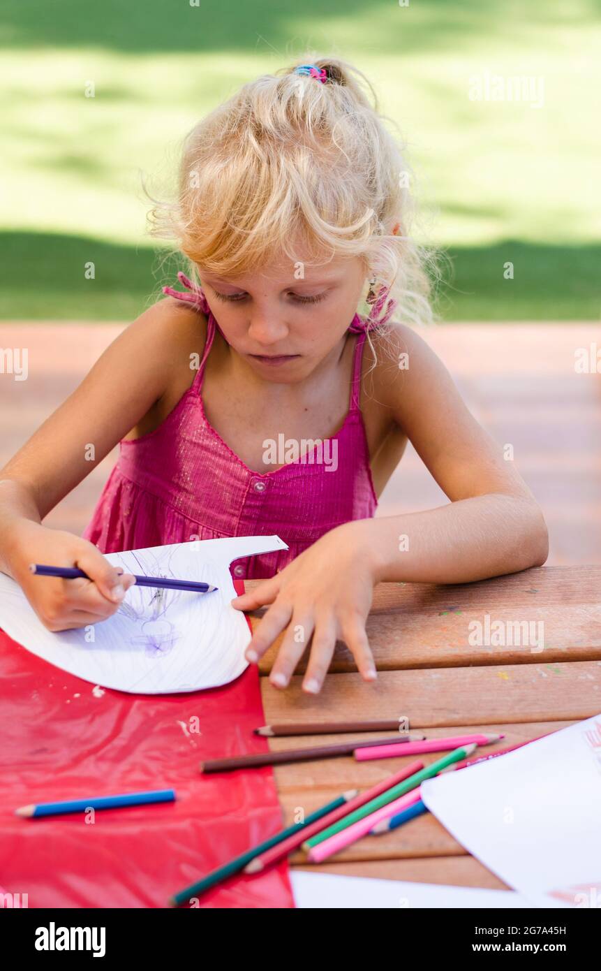 lovely blond girl drawing an image Stock Photo - Alamy