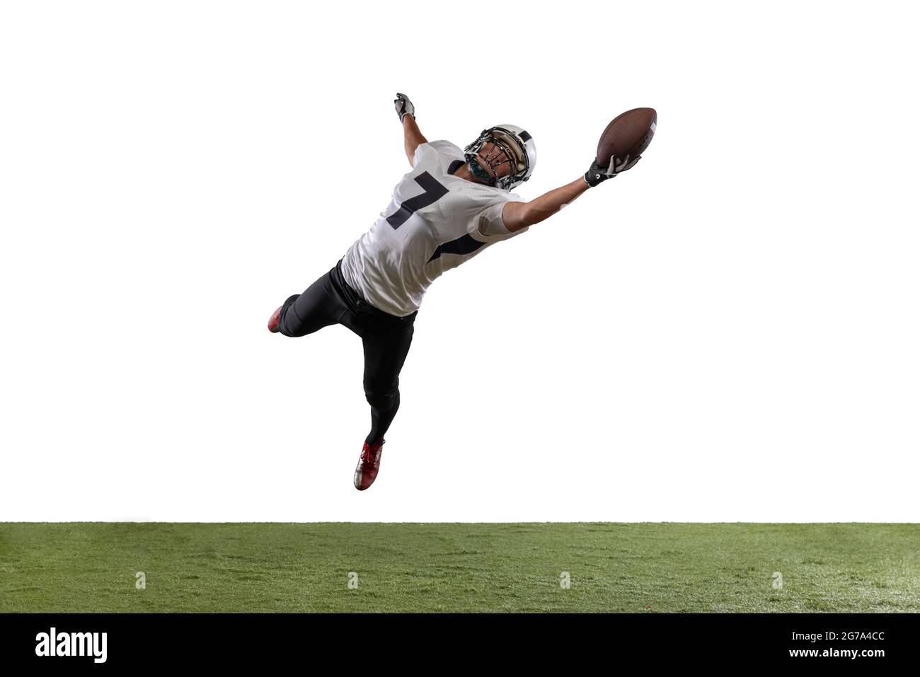 Portrait of American football player catching ball in jump isolated on ...