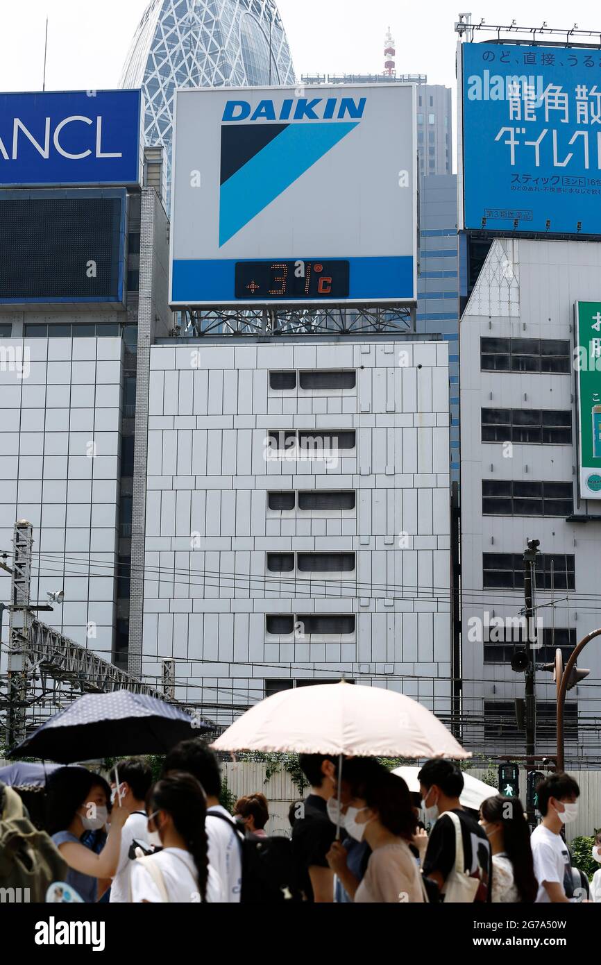 A thermometer marks 31 C degrees in Shinjuku district on July 11, 2021 ...