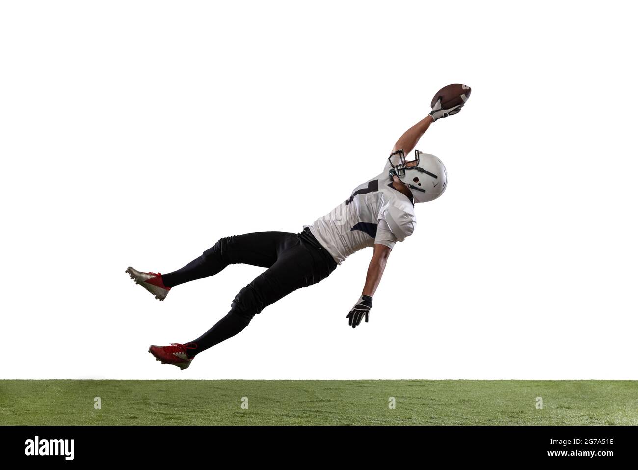 Portrait of American football player catching ball in jump isolated on ...