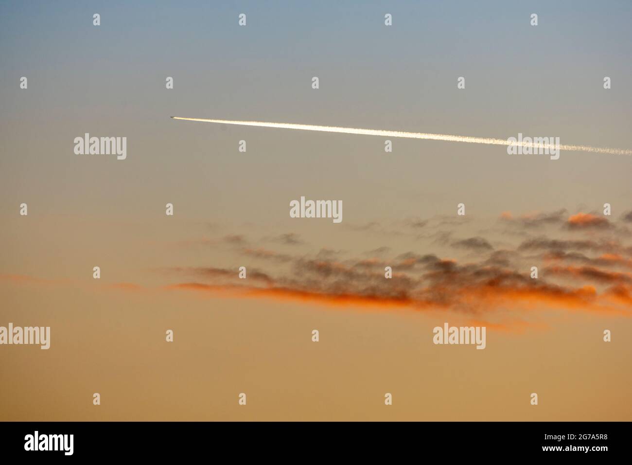 Contrails at sunset hi-res stock photography and images - Alamy