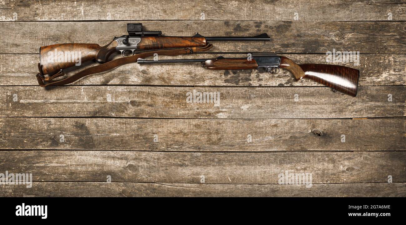 Hunting weapon on dark wooden backgorund, top view Stock Photo - Alamy