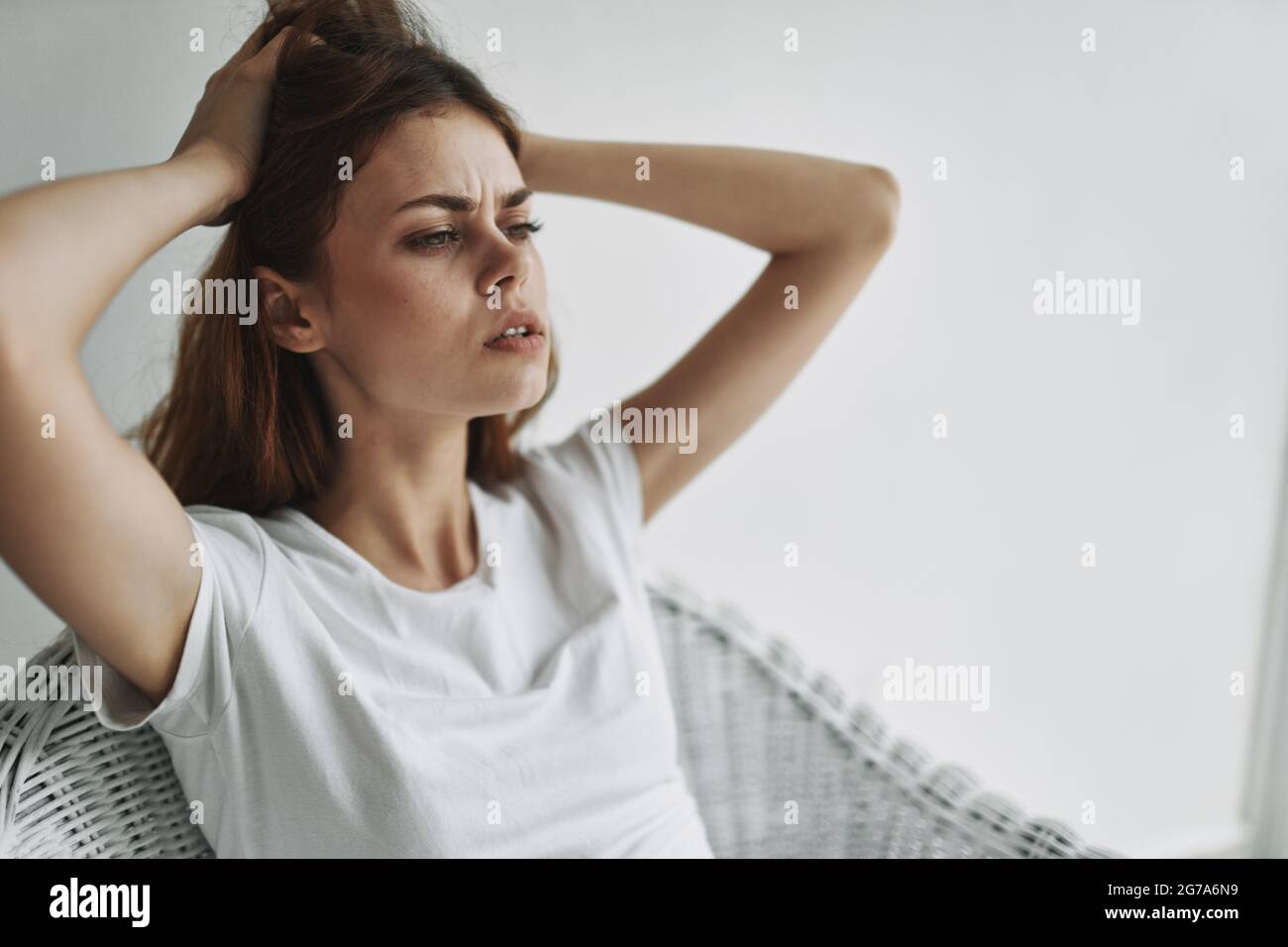 woman sitting in a chair at home emotions discontent depression Stock ...