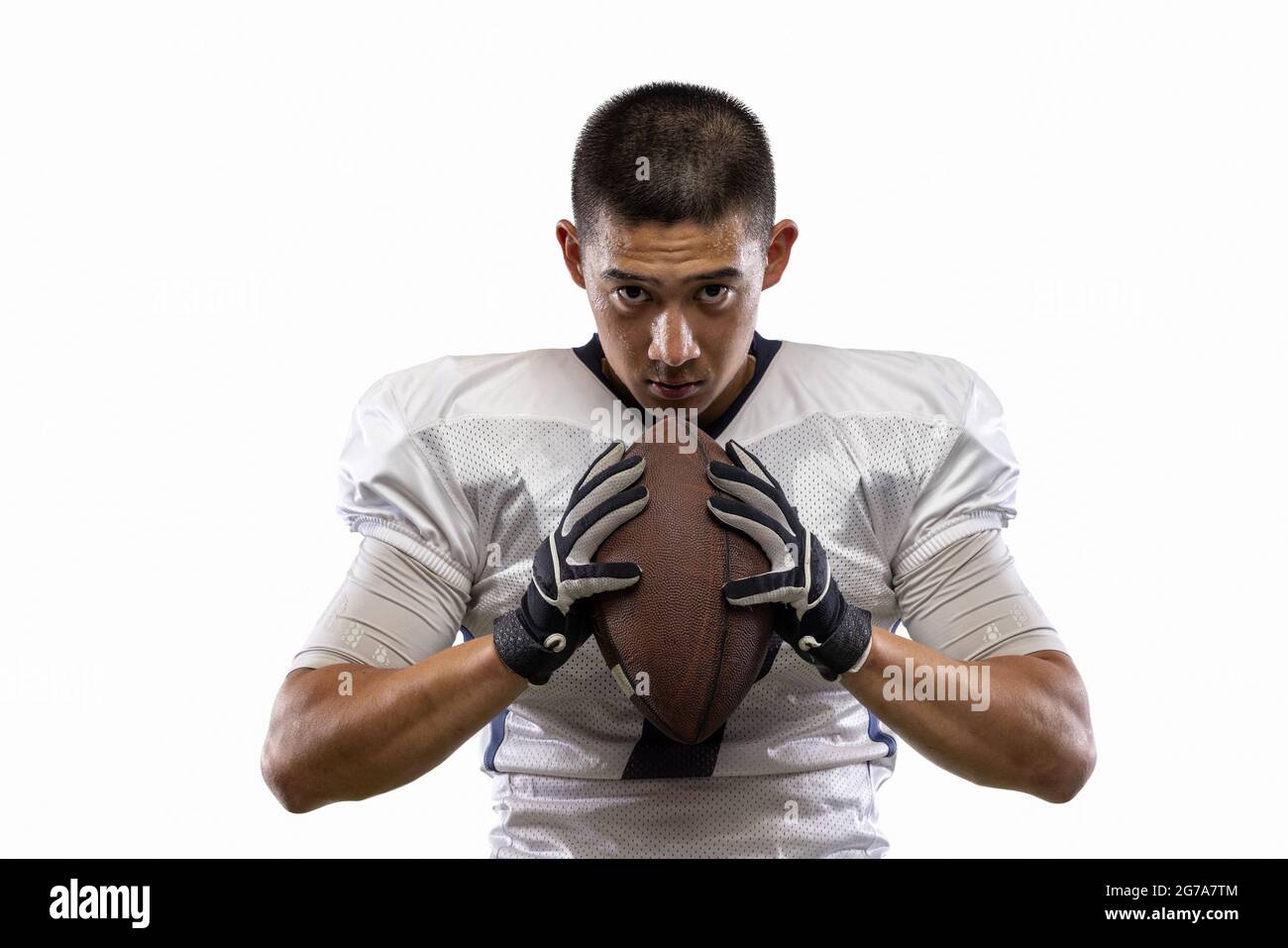 Close-up young American football player, athlete posing isolated on ...