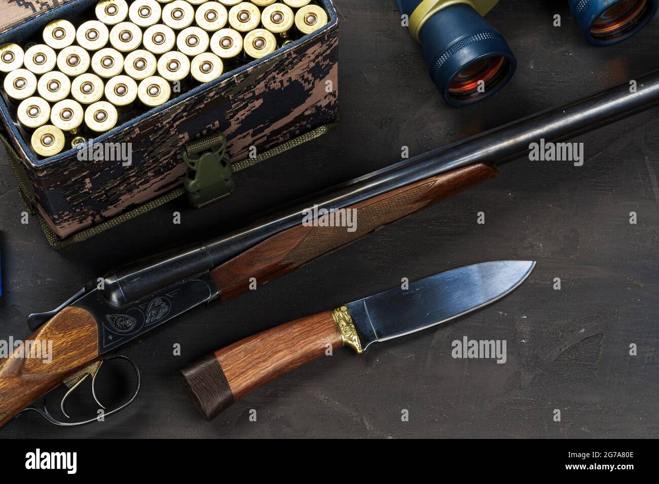 Hunting rifle and cartridges on dark wooden background Stock Photo - Alamy