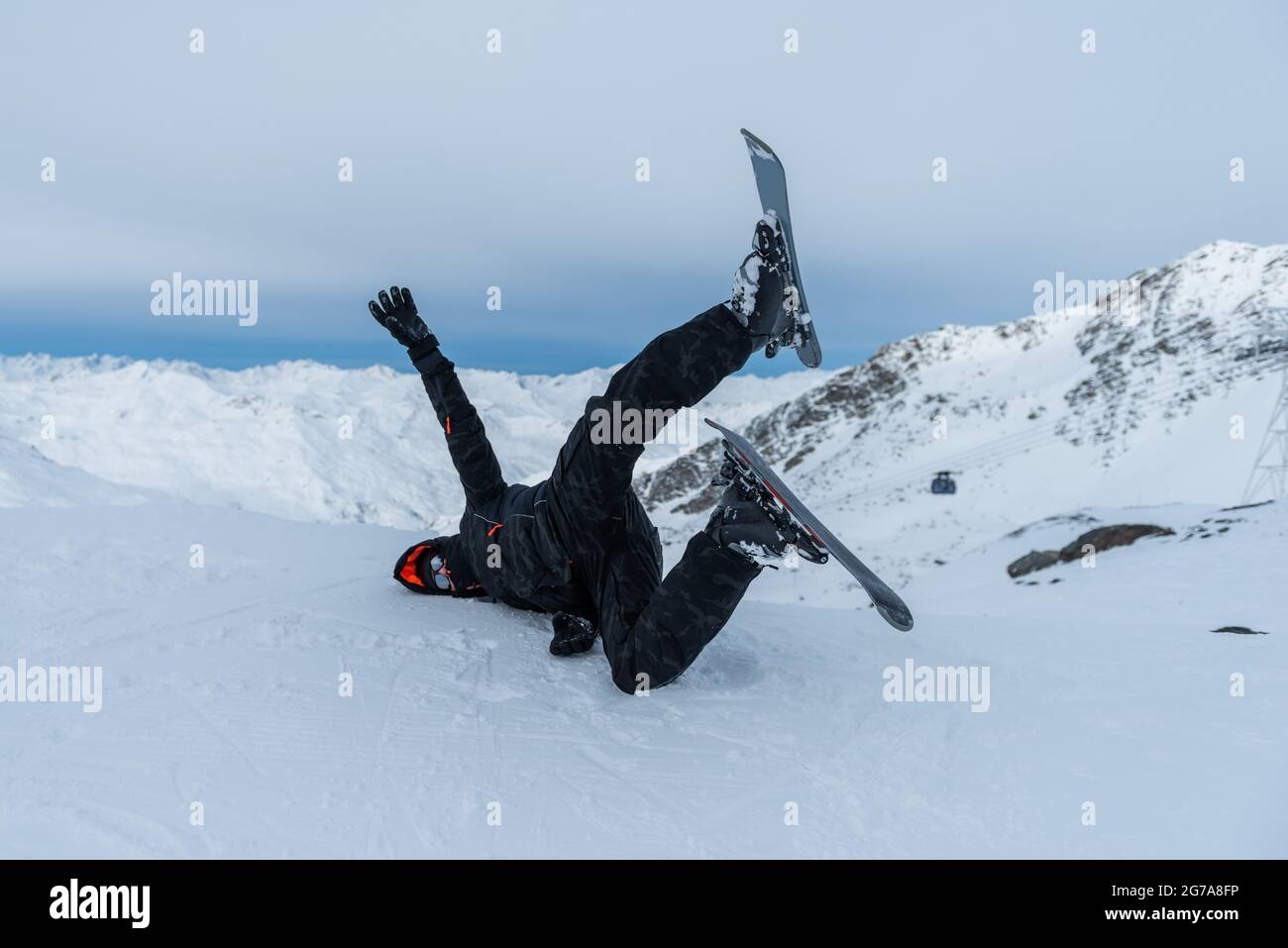 a man skier falling in the snow on top of the mountain Stock Photo - Alamy