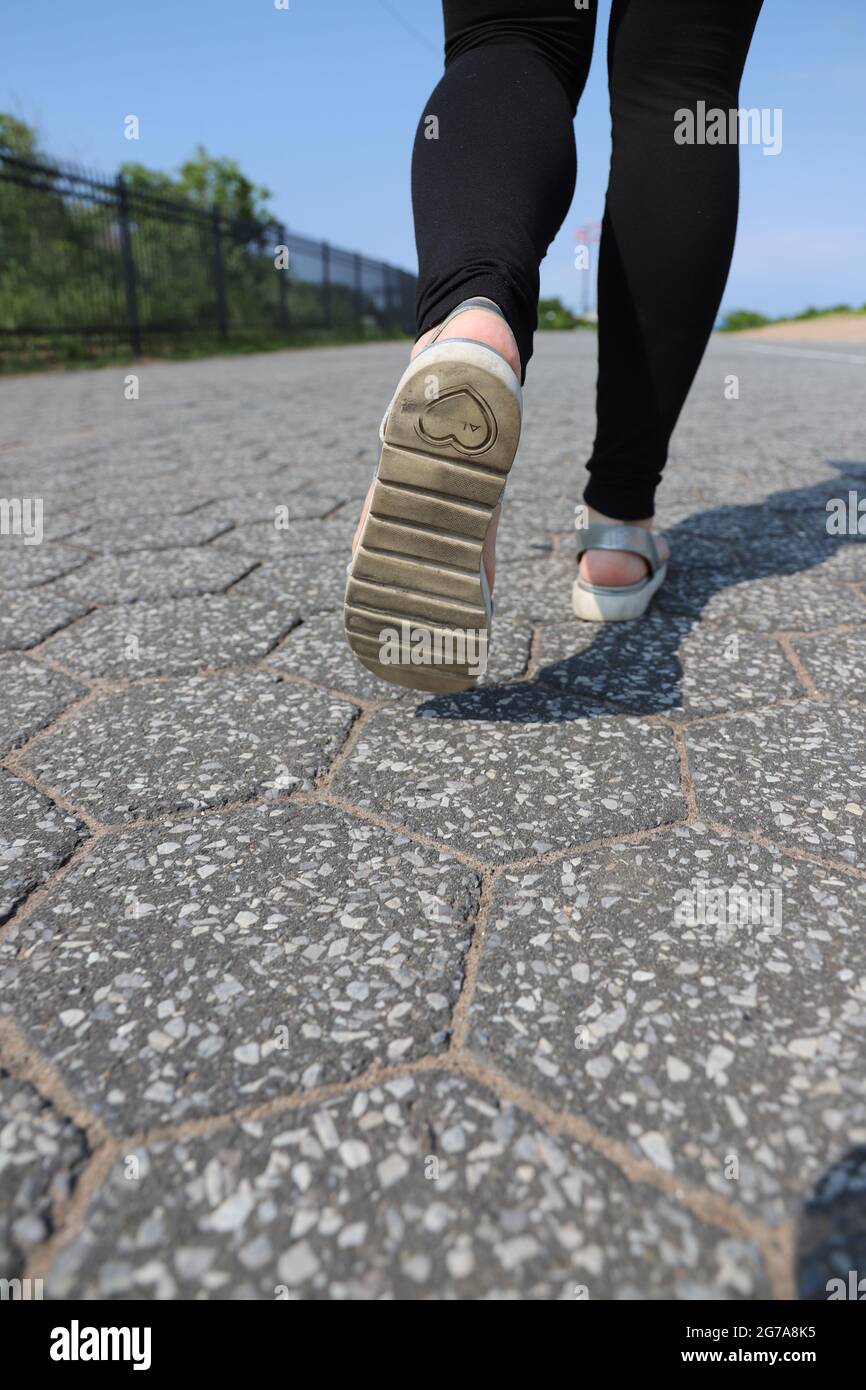 Back view of woman legs walking in a park a sunny day Stock Photo - Alamy