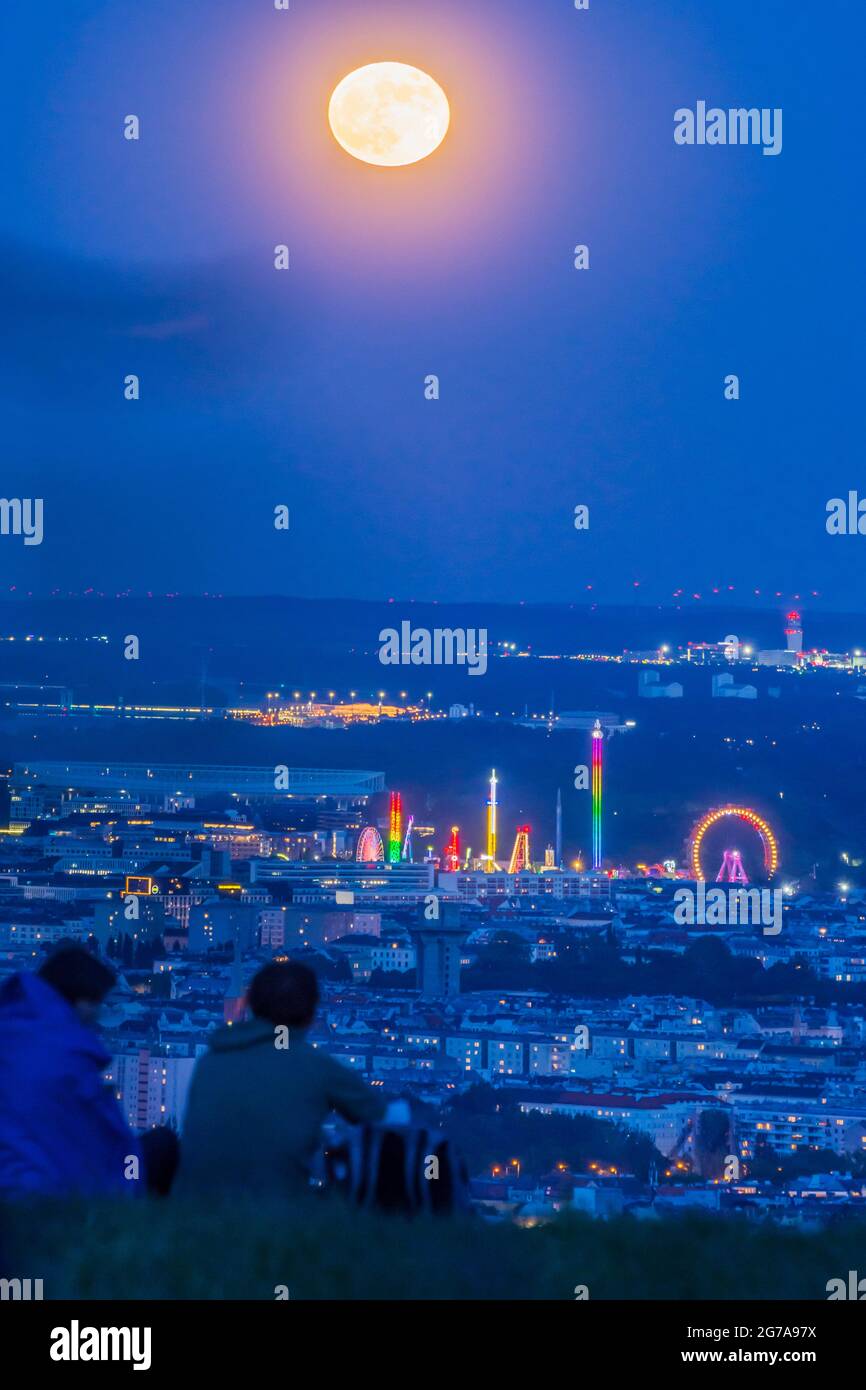 Vienna, rising super full moon above Vienna, Prater and Ferris Wheel ...