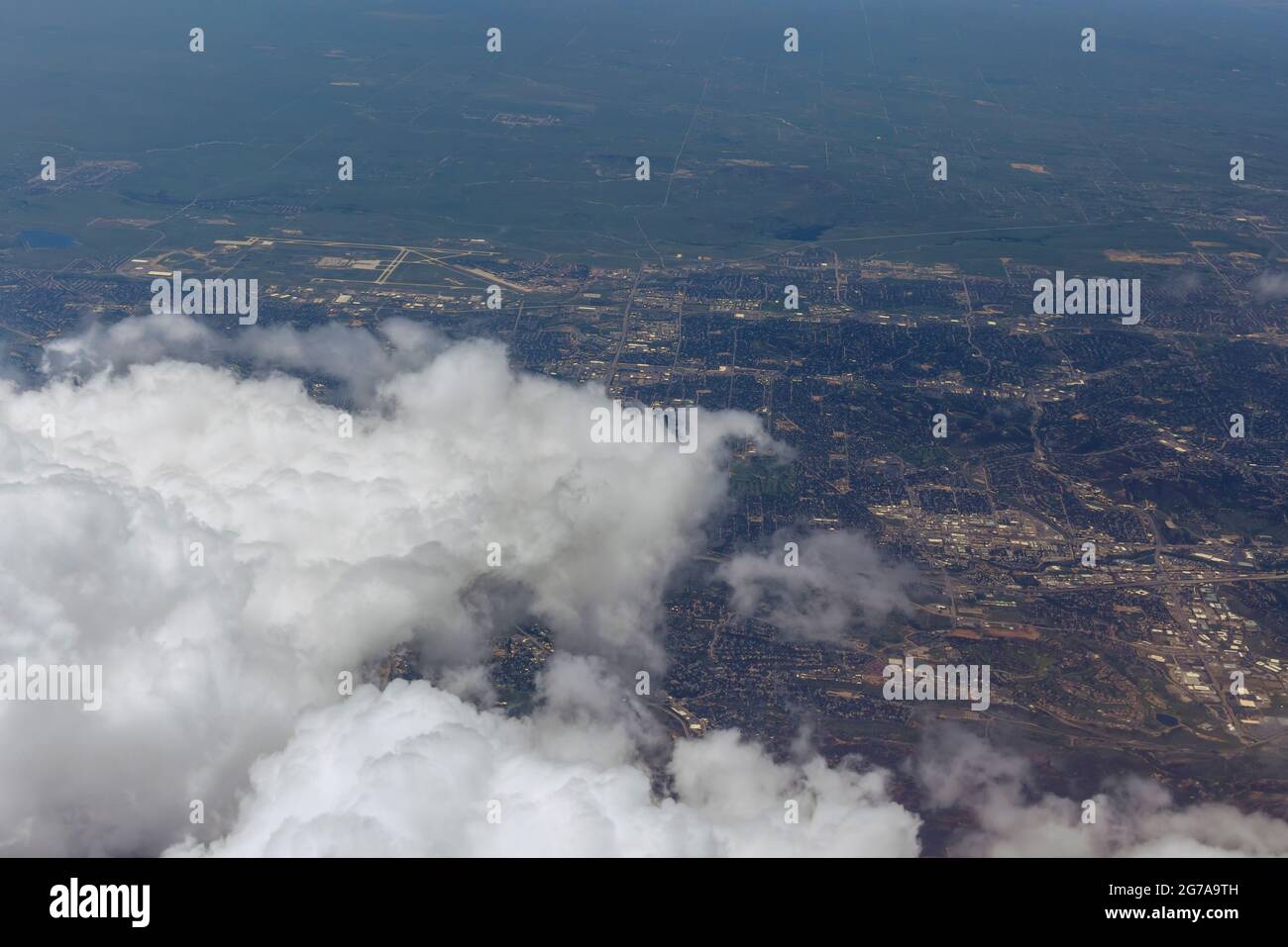 Aircraft flying over the landscape flight above the clouds and city ...