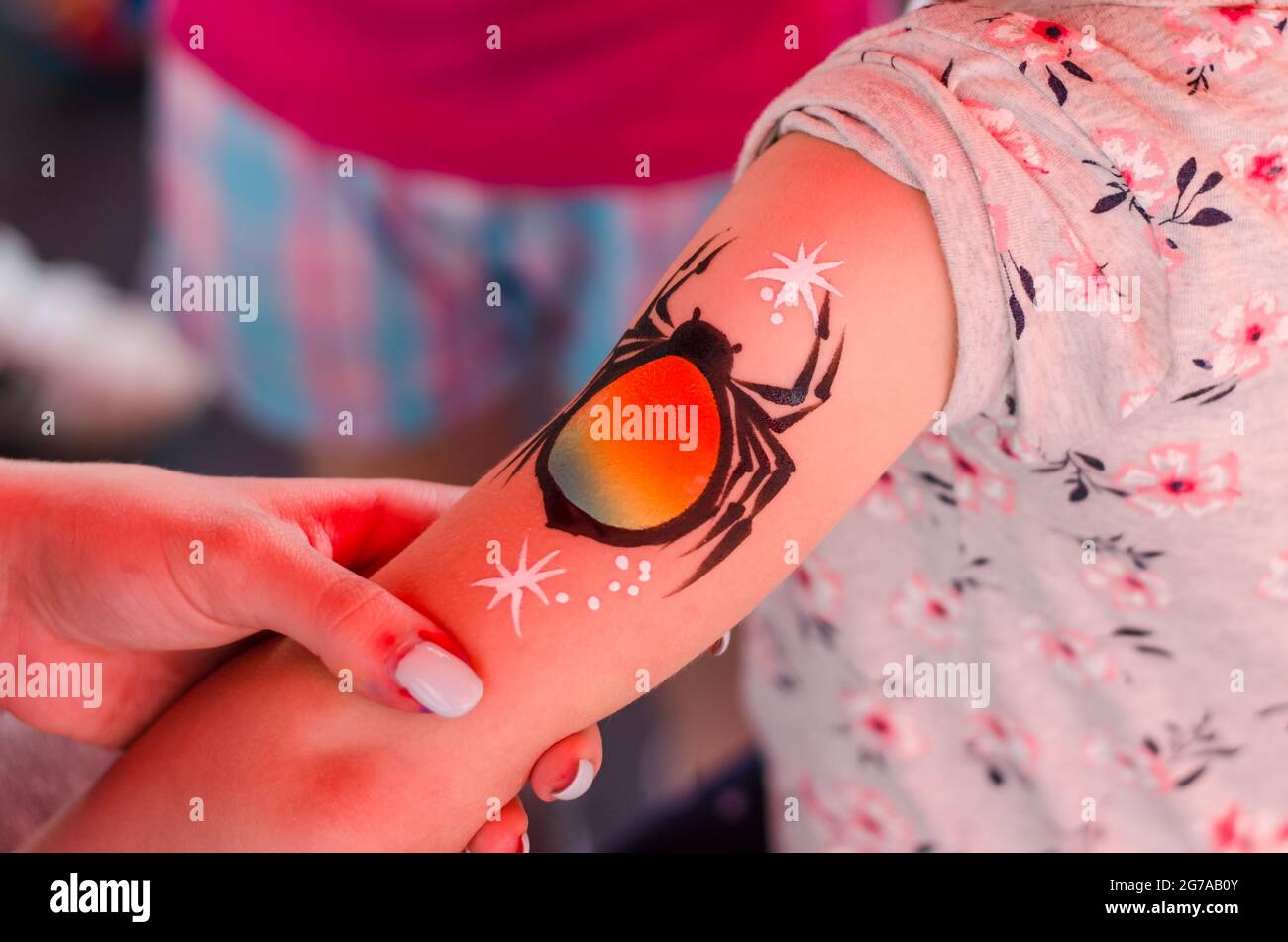 colorful spider painting in hand Stock Photo - Alamy