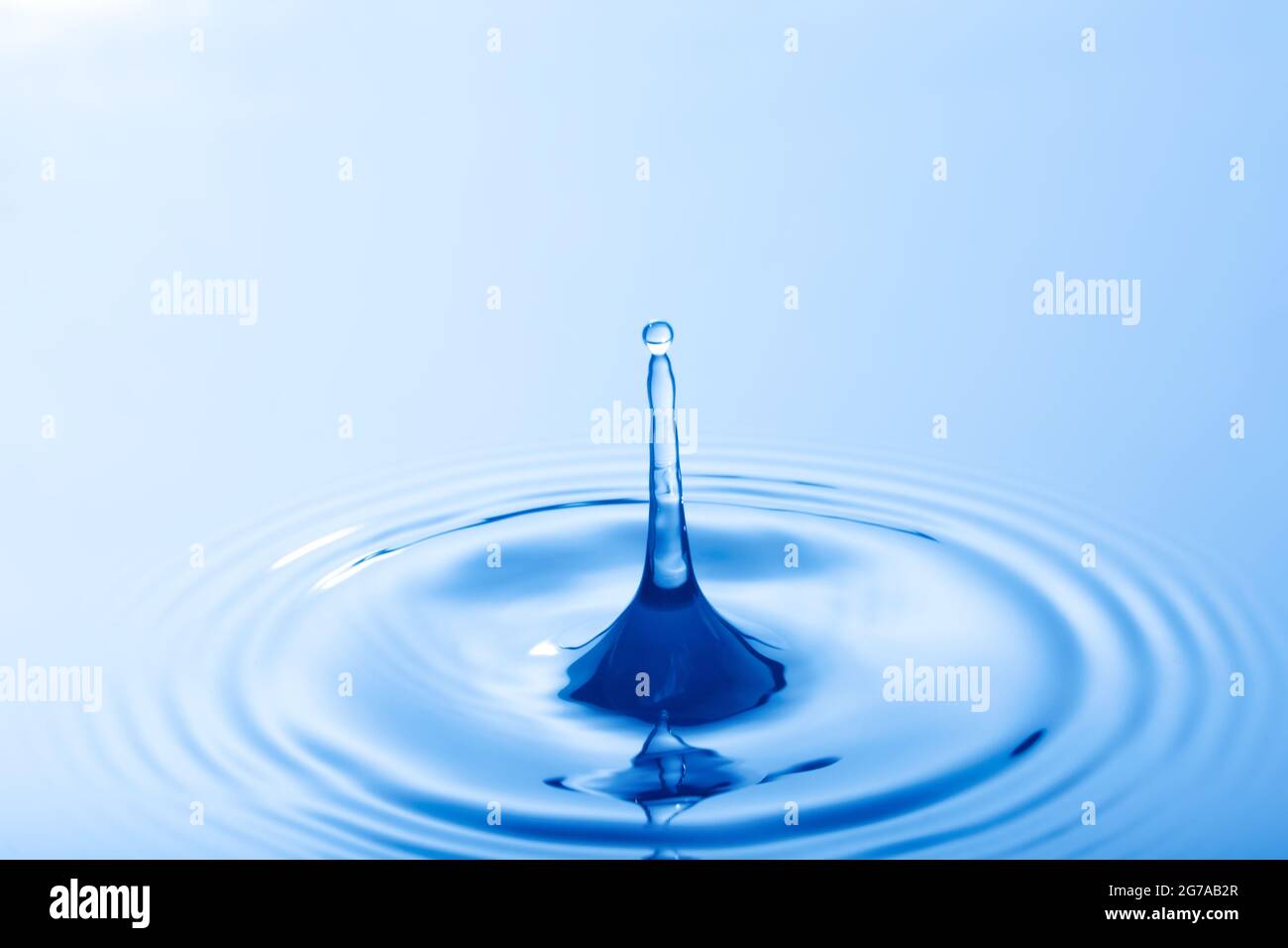 Drop of water. Water droplet falling impact with water surface. causing ...