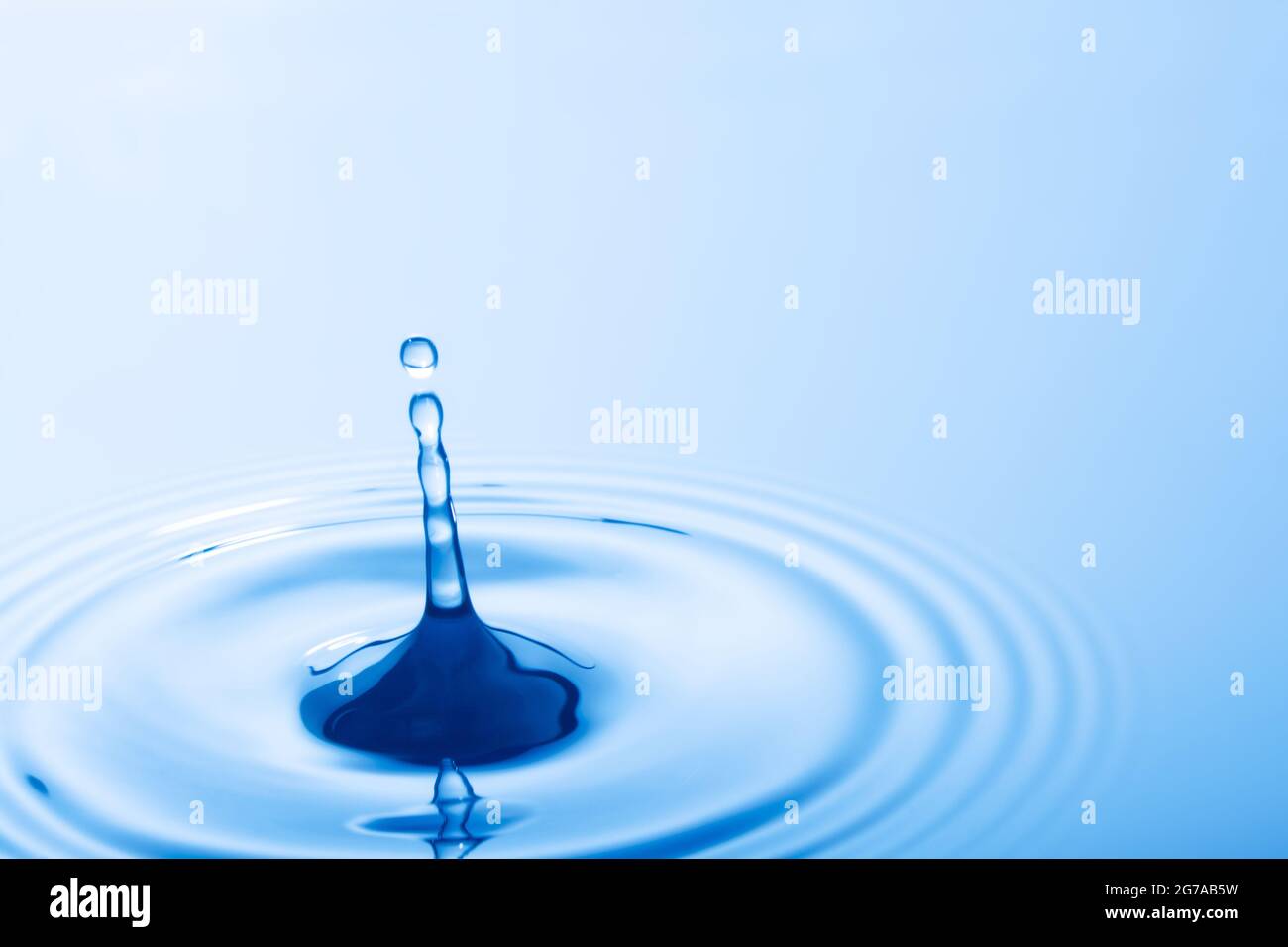 Drop of water. Water droplet falling impact with water surface. causing ...