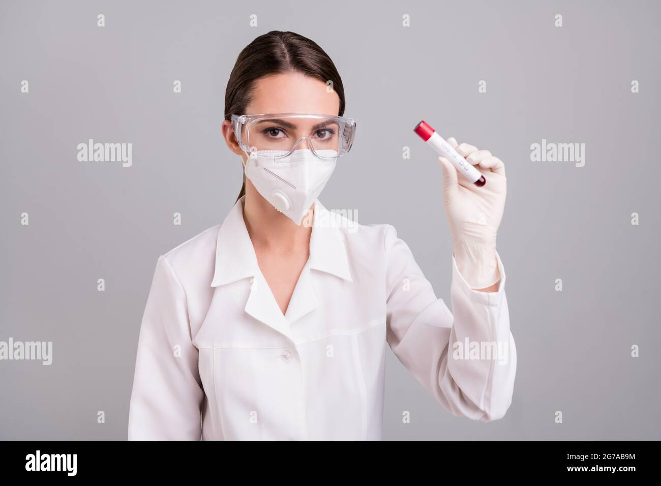 Photo of sweet serious young doc woman dressed white coat goggles ...