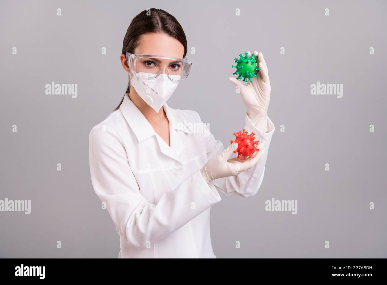 Photo of serious attentive young doc woman dressed white coat goggles ...