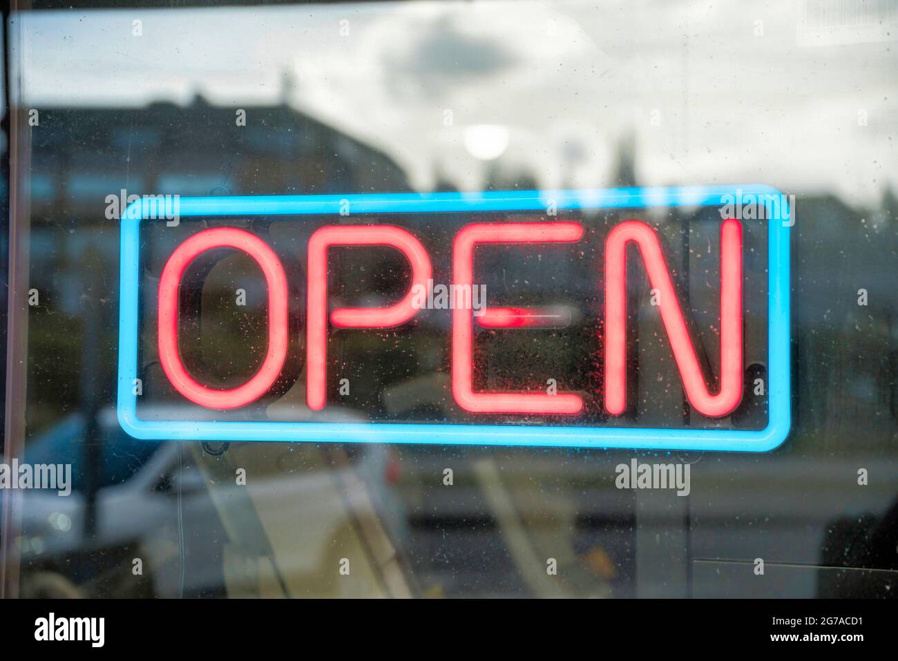 Neon sign of open with red letters and the border as blue Stock Photo ...