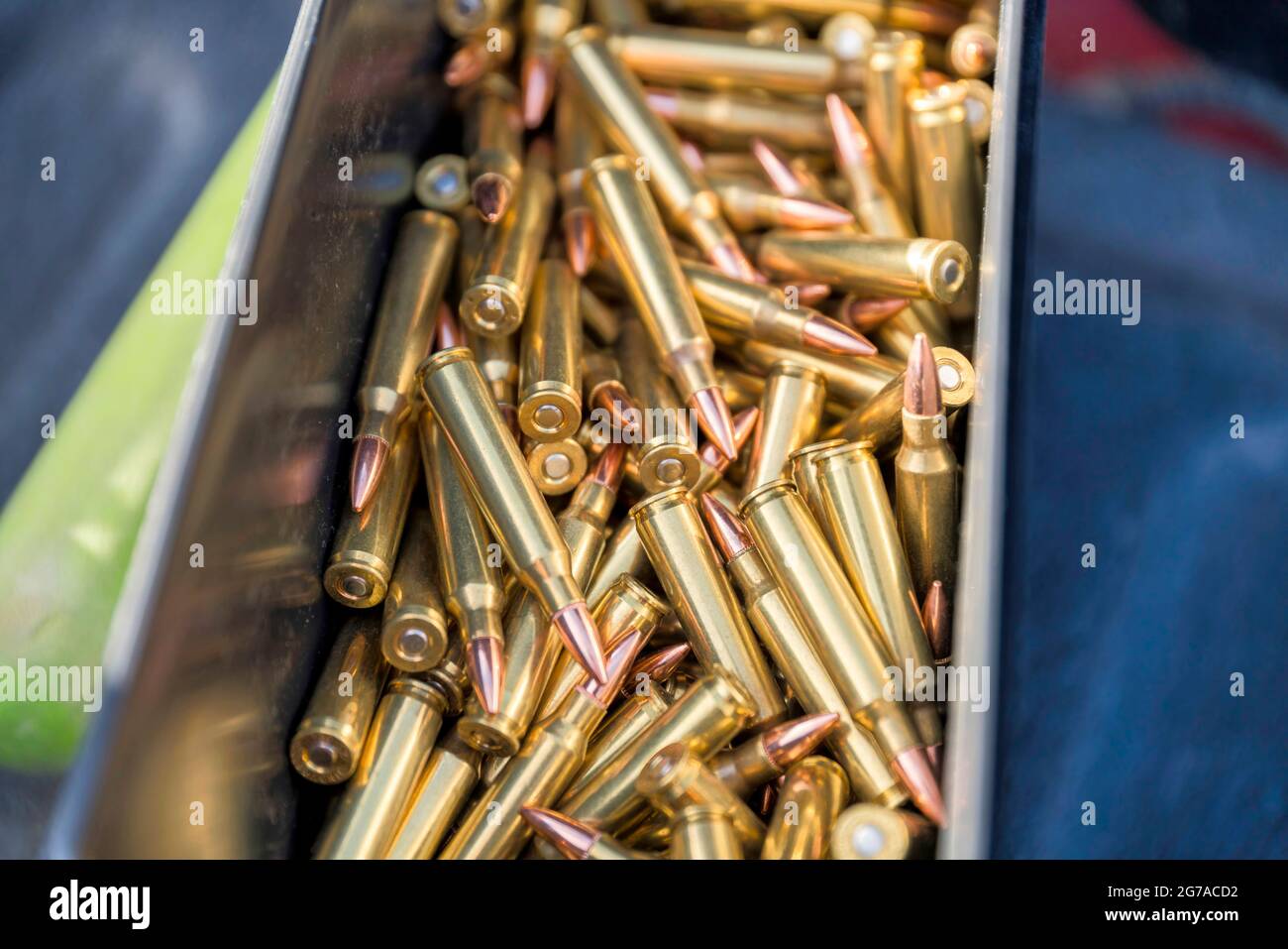 Loads of long sharp bullets inside its case with a blue cloth on the ...