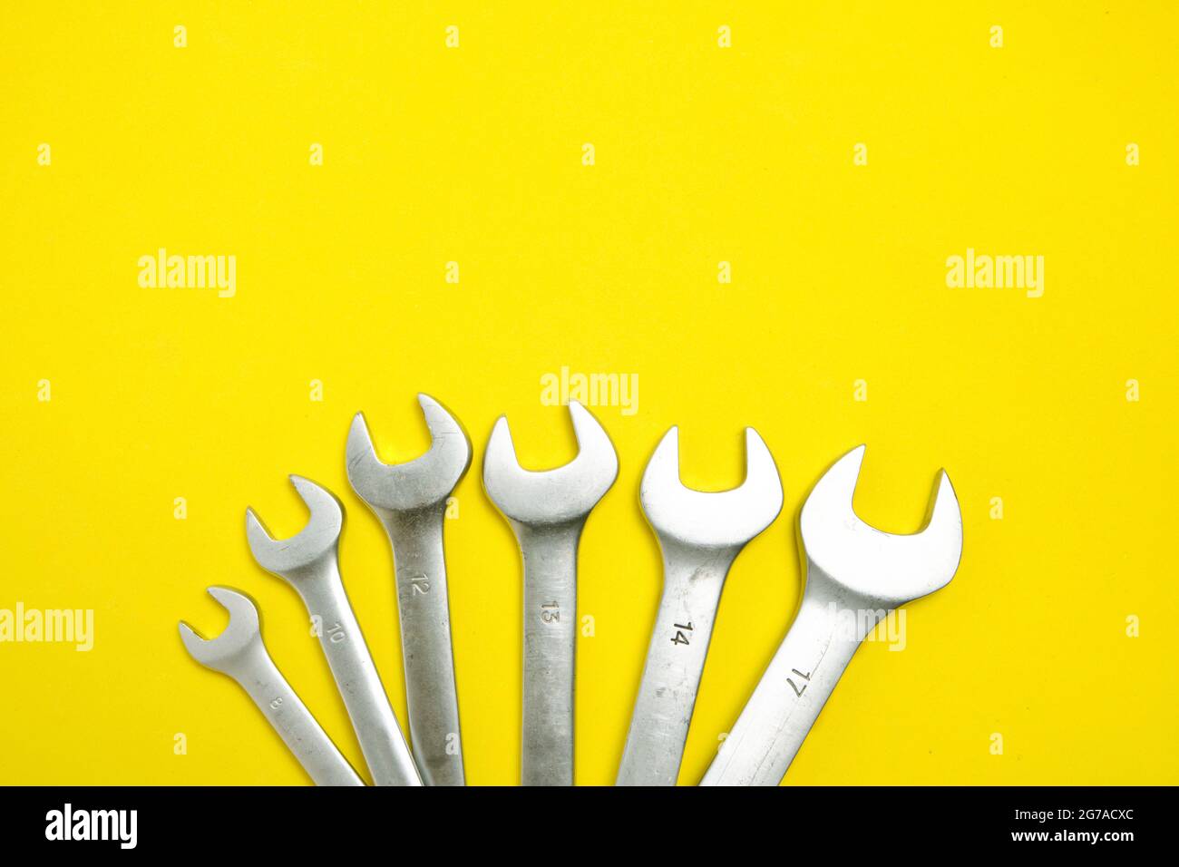 Set of wrenches on a yellow background Stock Photo - Alamy