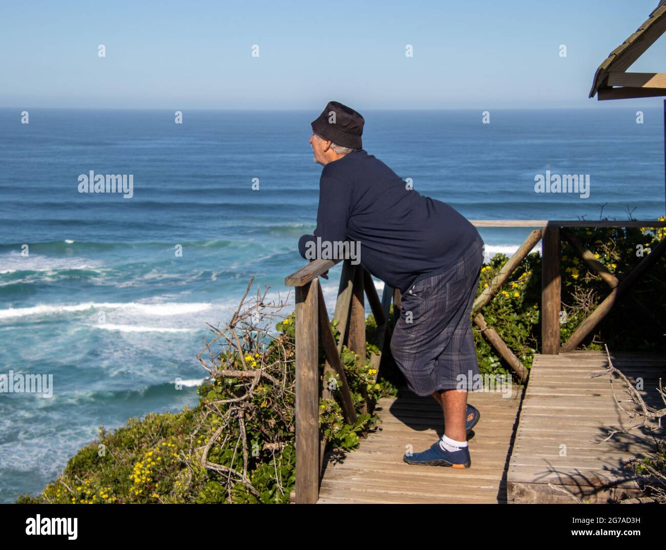 Plettenburg Bay, South Africa - an elderly man looks out over the ocean ...