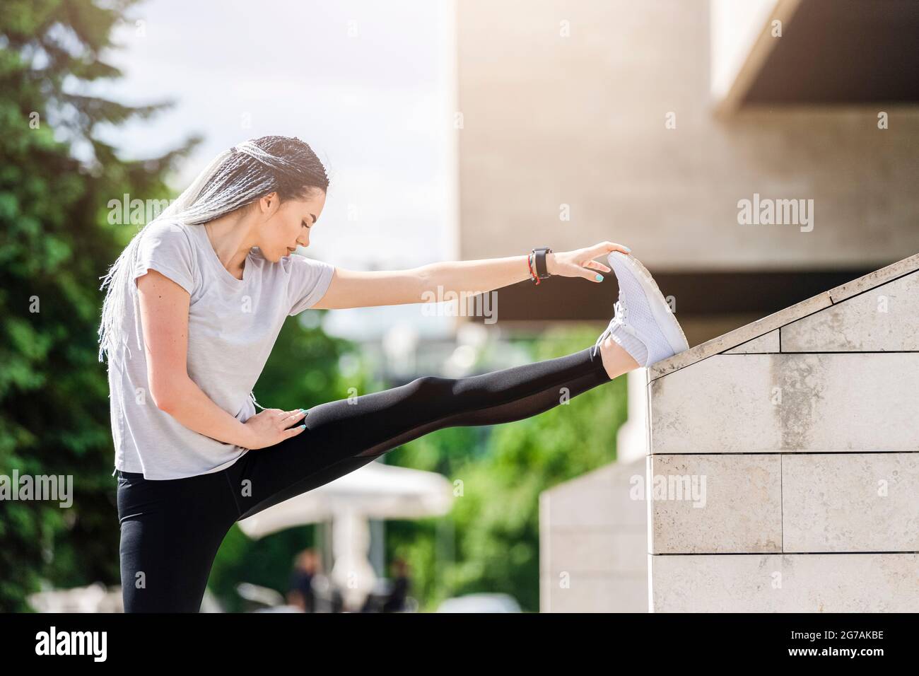 Fitness sport woman with african braids doing stretching exercise in ...