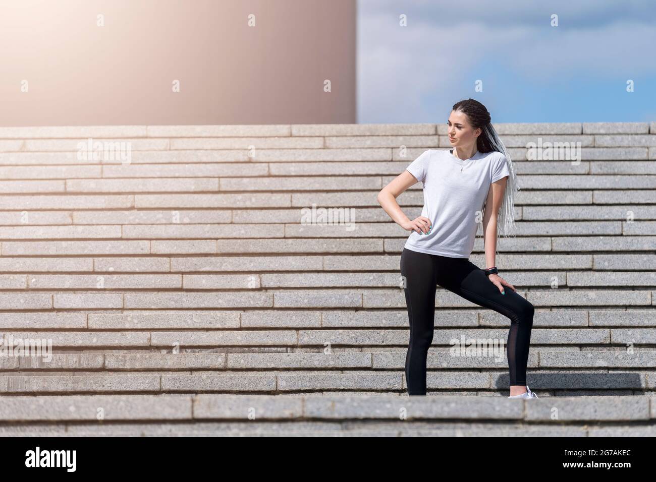 Fitness girl jumping on stairs during her morning workout. Urban sport ...