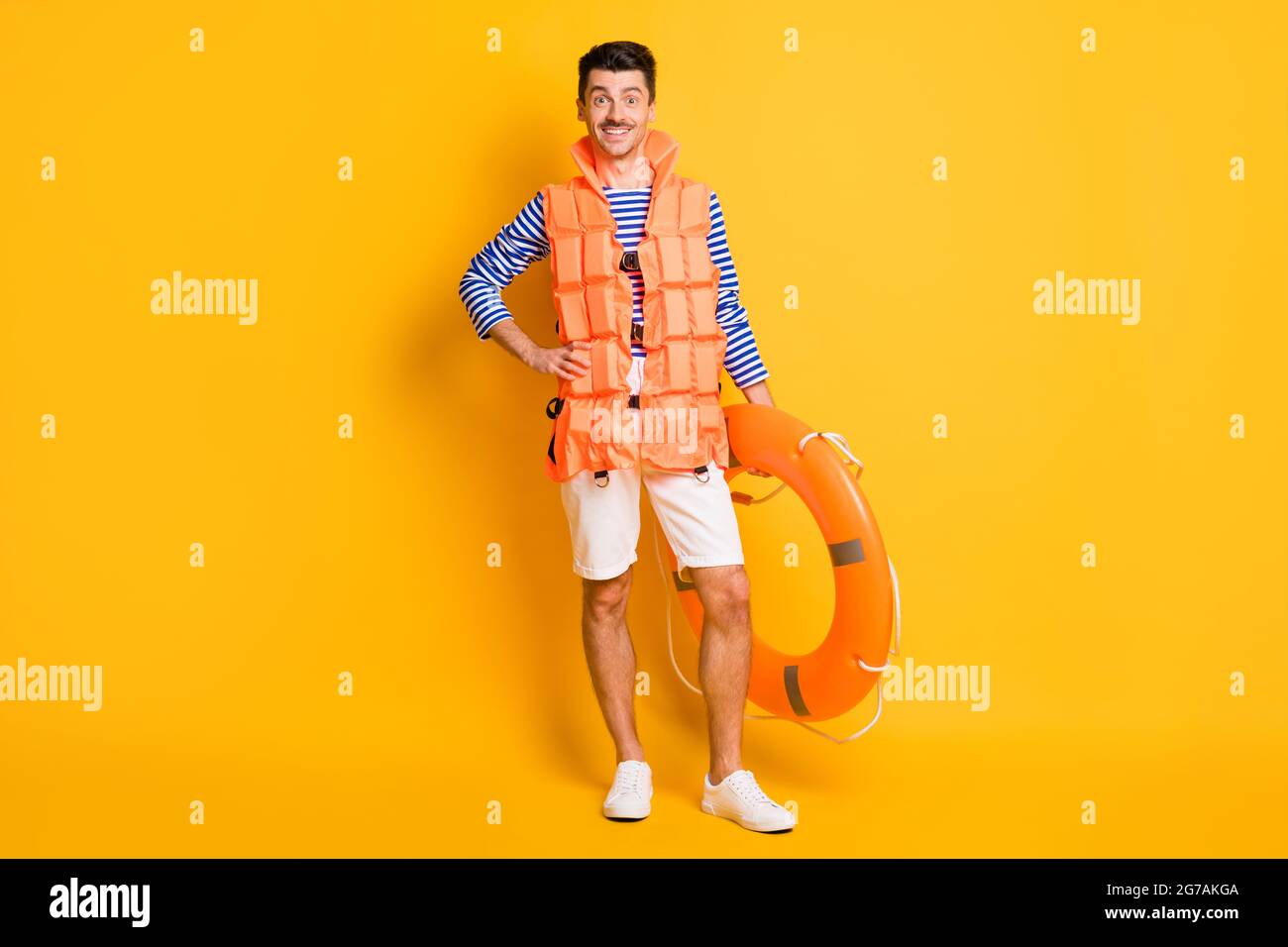 Full body photo of young happy man hold lifeguard circle wear vest ...
