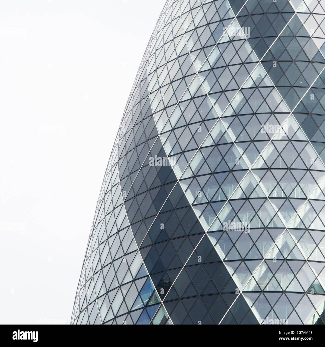 Close-up of a beautiful glass building with offices in the city. Cloudy ...