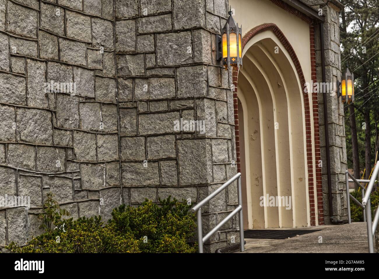 Vintage old stone wall and gothic entrance with illuminated lights ...