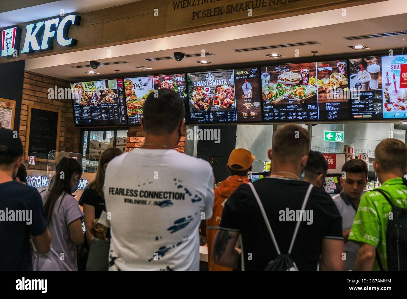 People wait for their orders at a KFC restaurant inside a shopping mall ...
