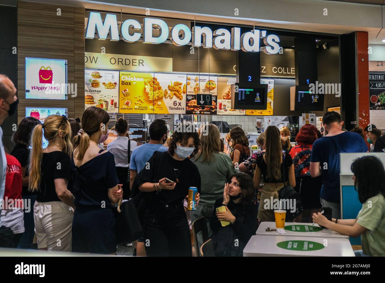 People wait for their orders at a McDonald's restaurant inside a ...