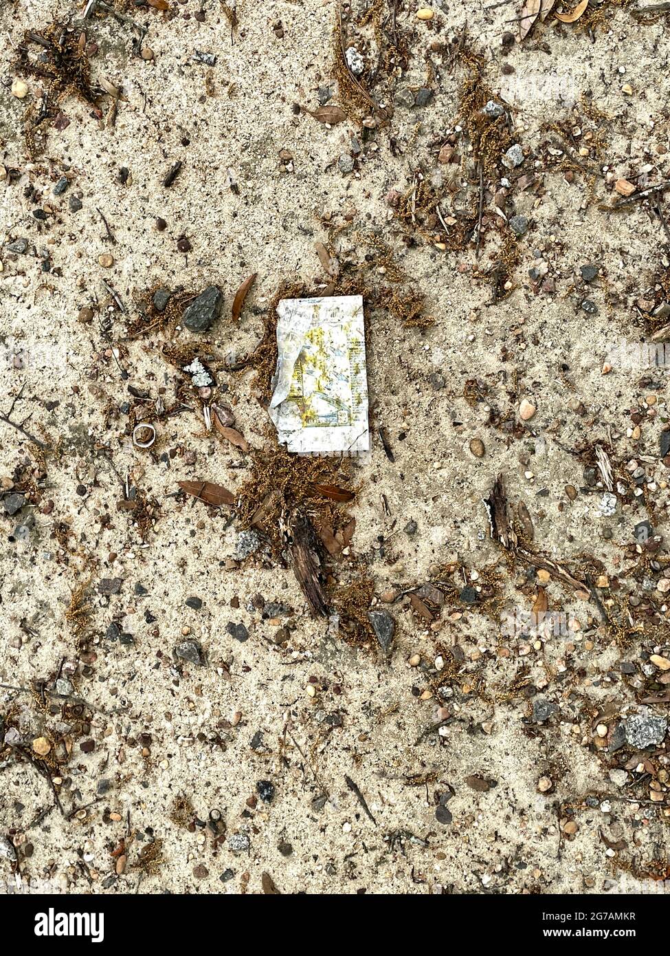 Trash waste litter on the ground with sand Stock Photo - Alamy