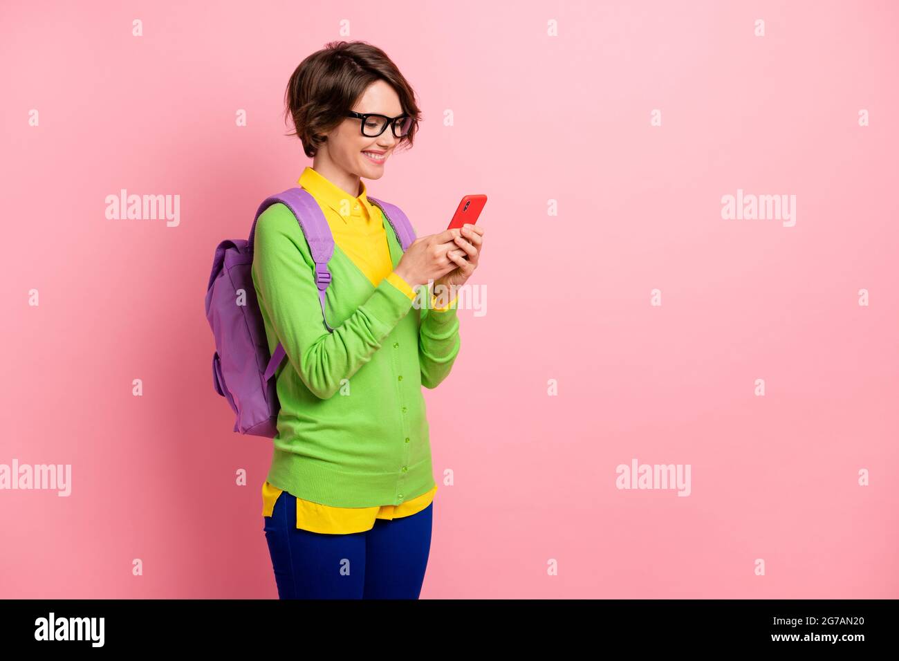 Photo of lady dressed yellow shirt glasses backpack holding looking ...