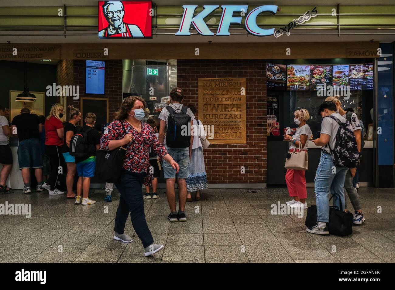 People wearing masks seen at a KFC restaurant inside a shopping mall ...