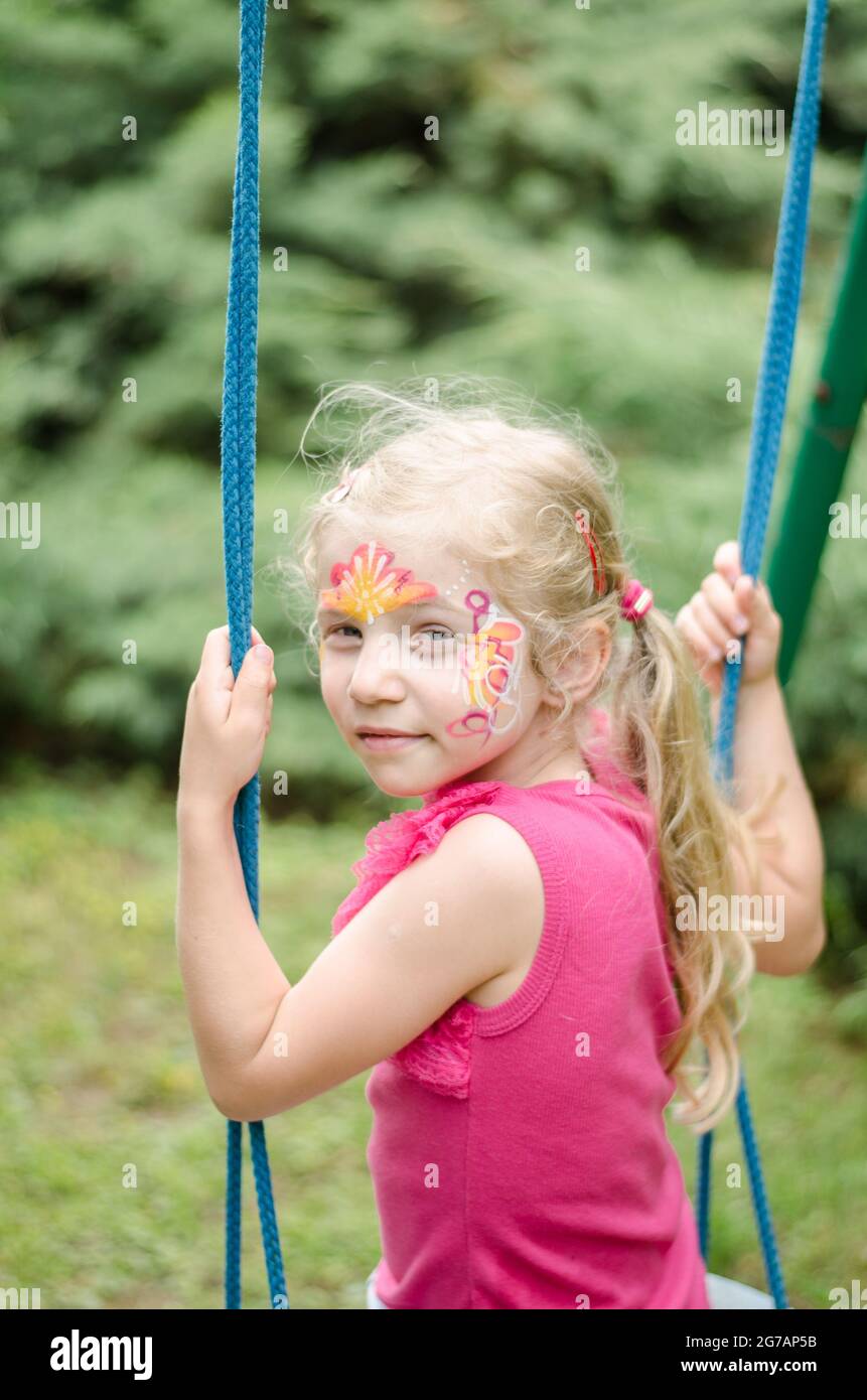 little child having fun swinging in the park Stock Photo - Alamy