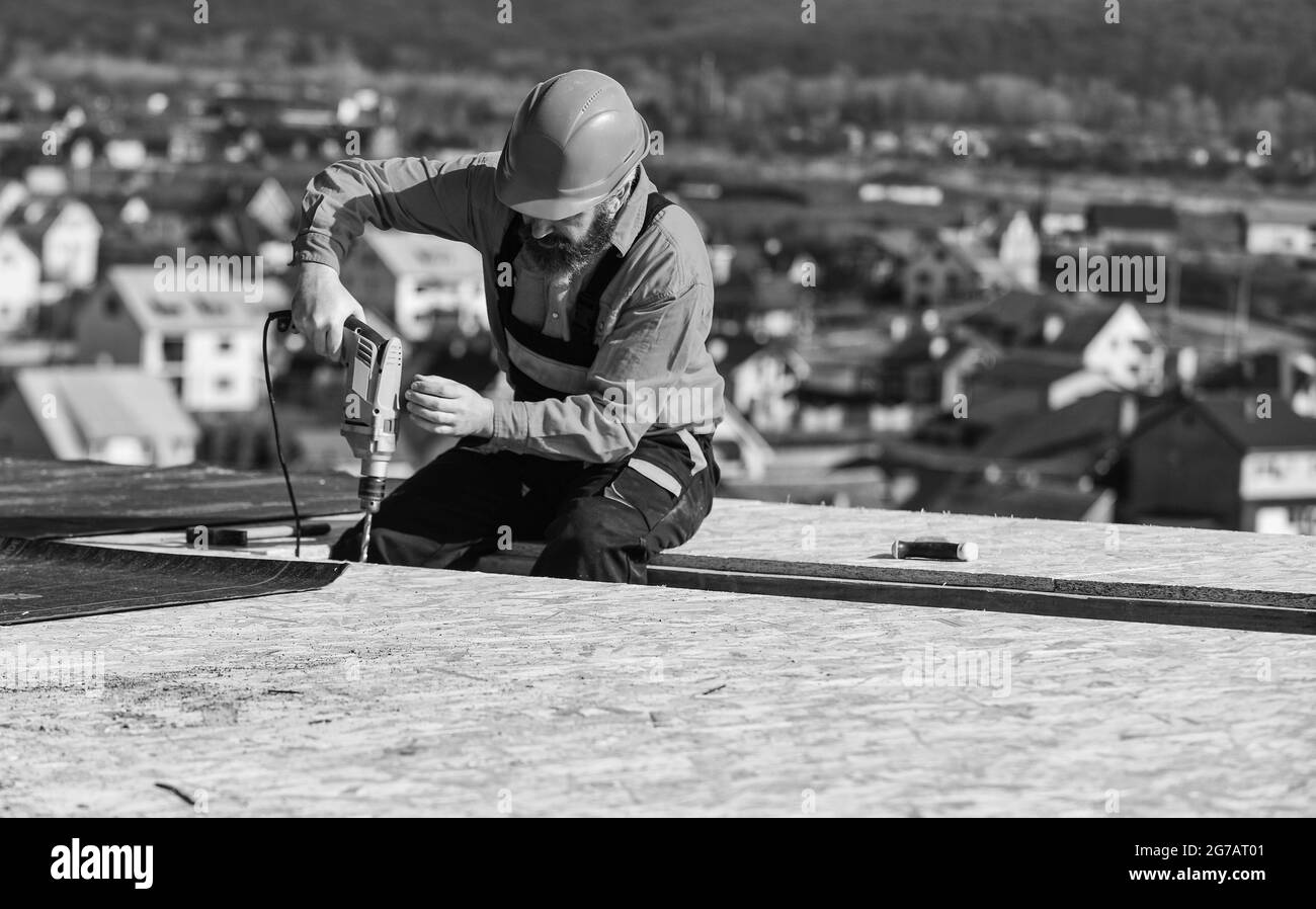 Master repair roof. Flat roof installation. Roofer constructing roof ...