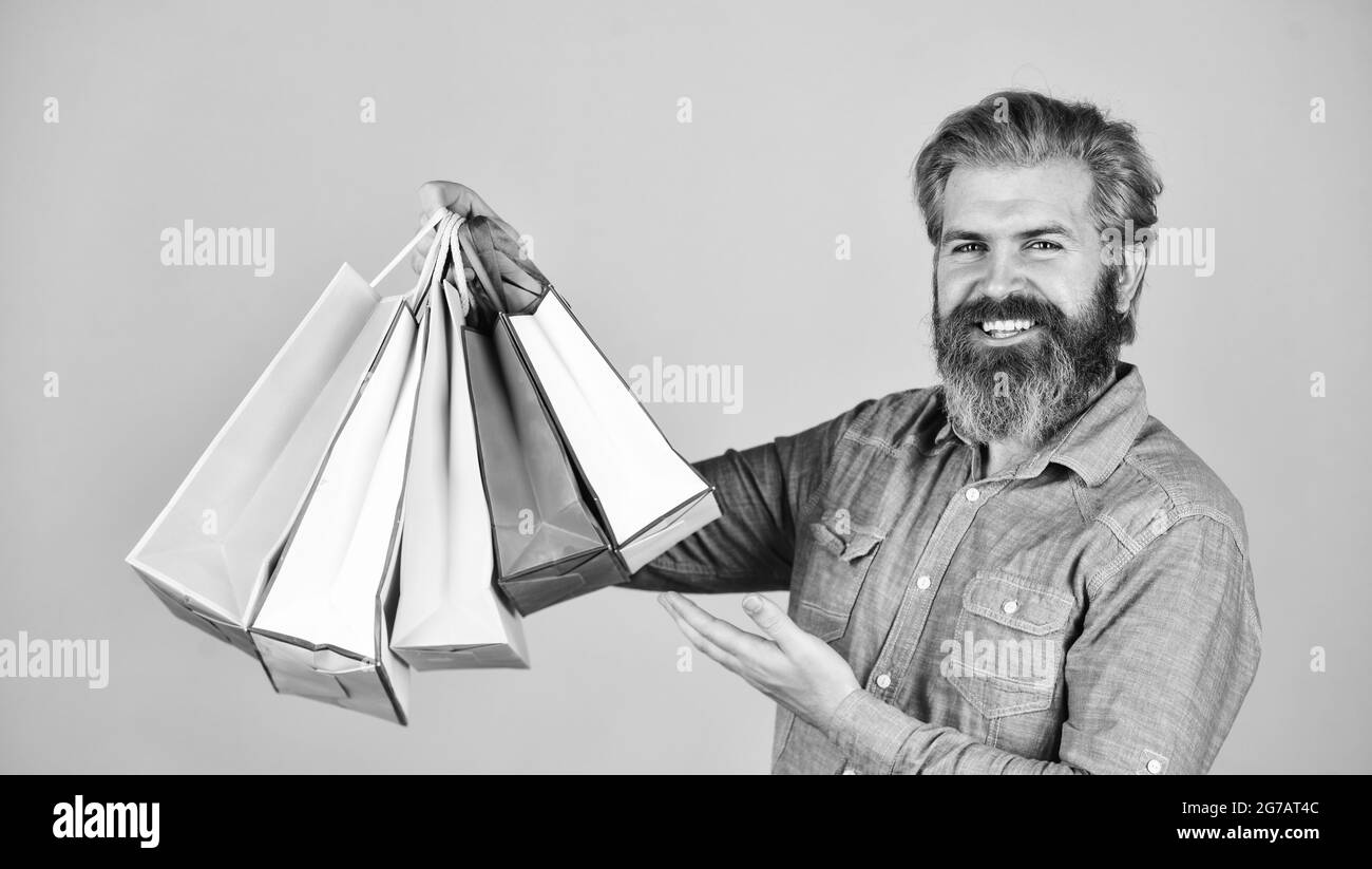 Delighted man shopping online. Extremely happy hipster making purchases ...