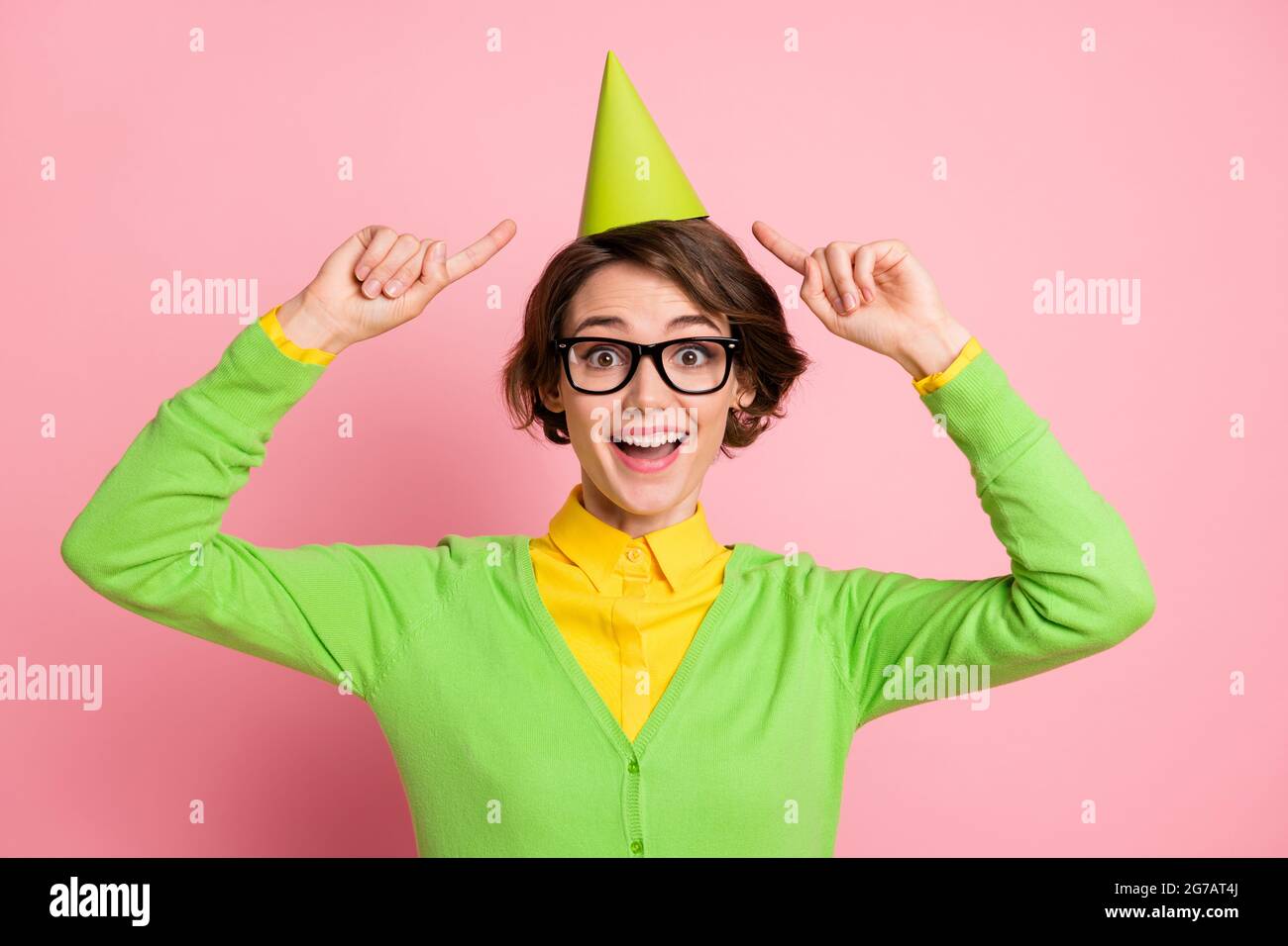 Photo of beautiful festive young woman point fingers cone hat wear ...