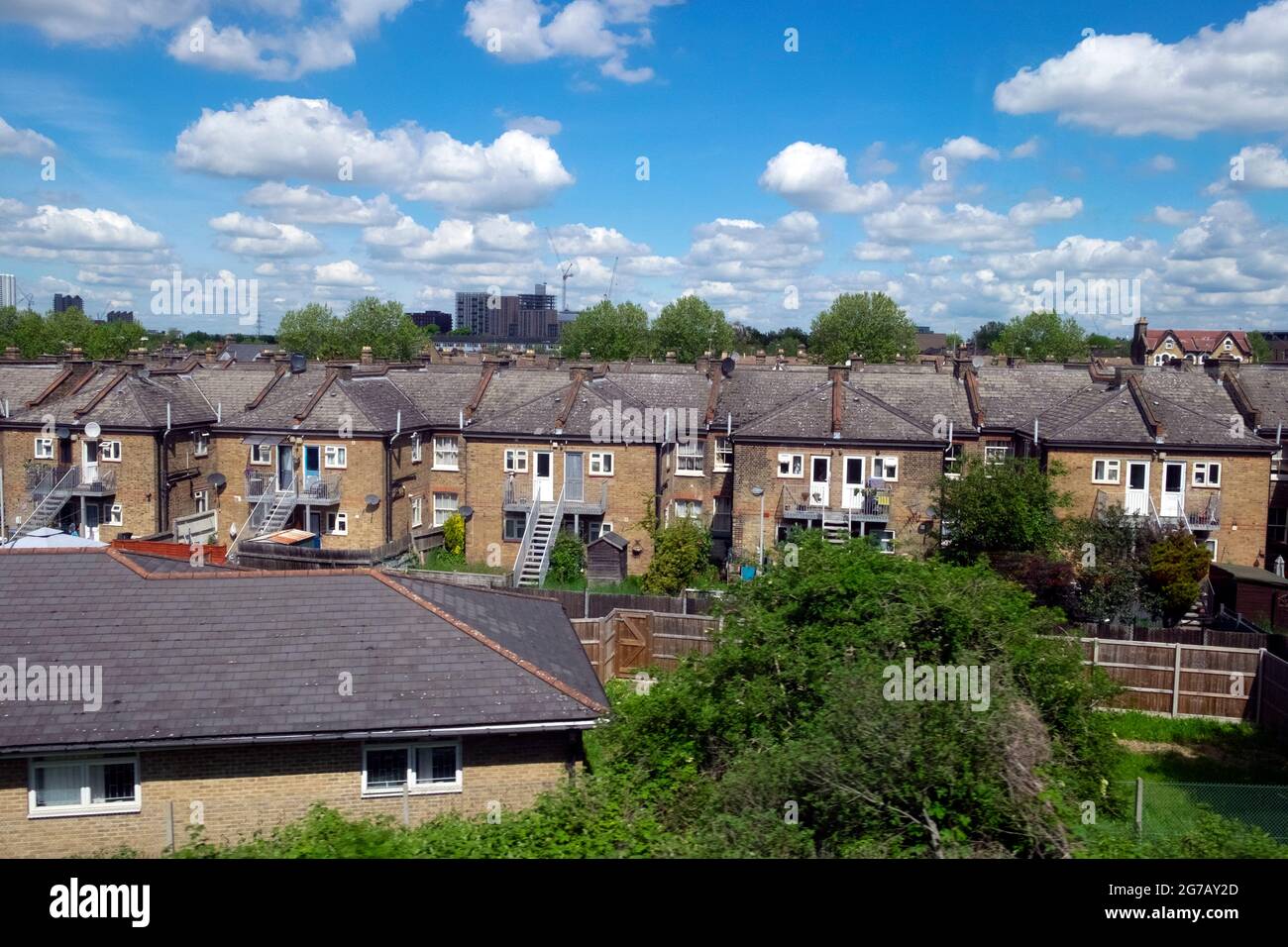 View from London overground train of the back of row of terraced ...