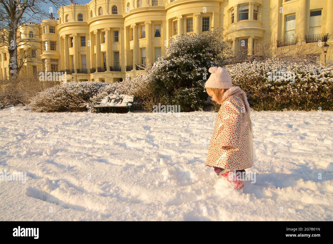 Toddler aged 2-3 ankle deep in fresh snow in Brunswick Square garden ...
