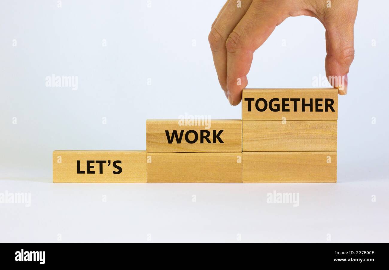 Work together symbol. Wooden blocks with words Let is work together on ...