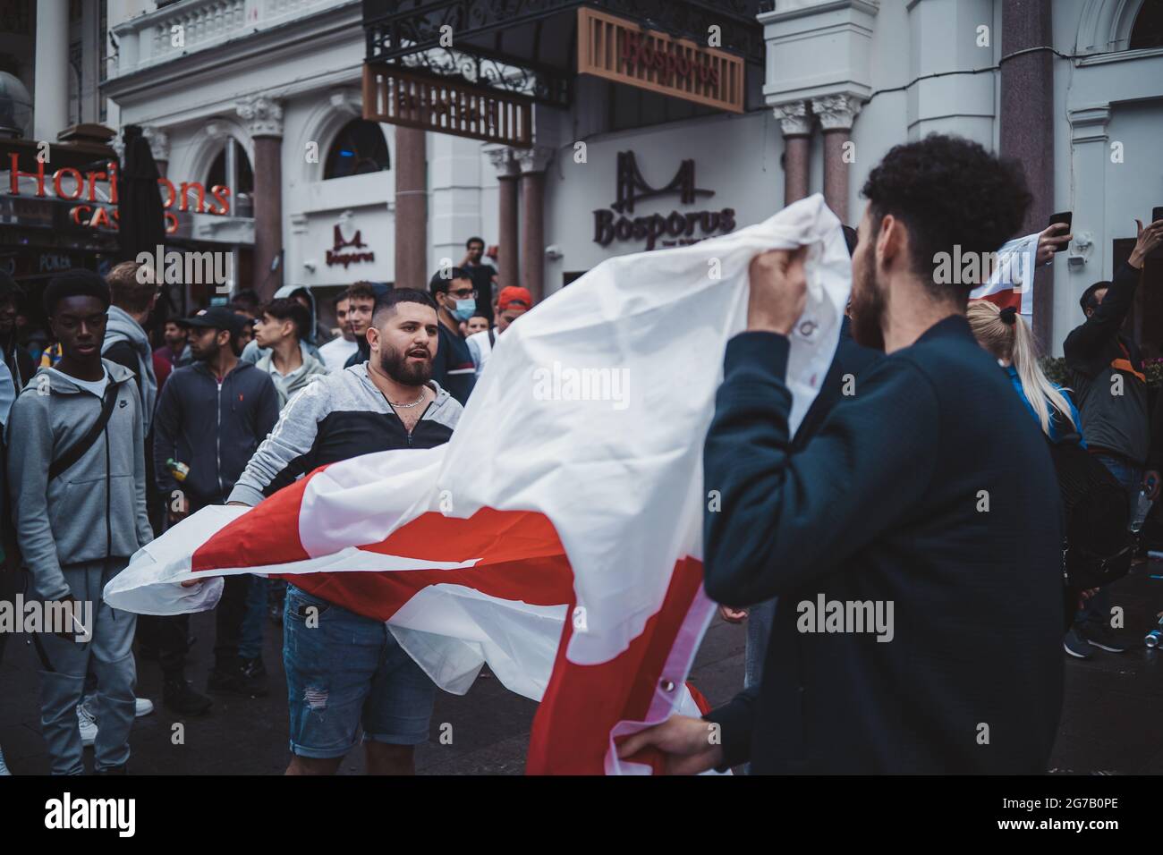 London | UK - 2021.07.12: English fans waving flags at Leicester Square ...