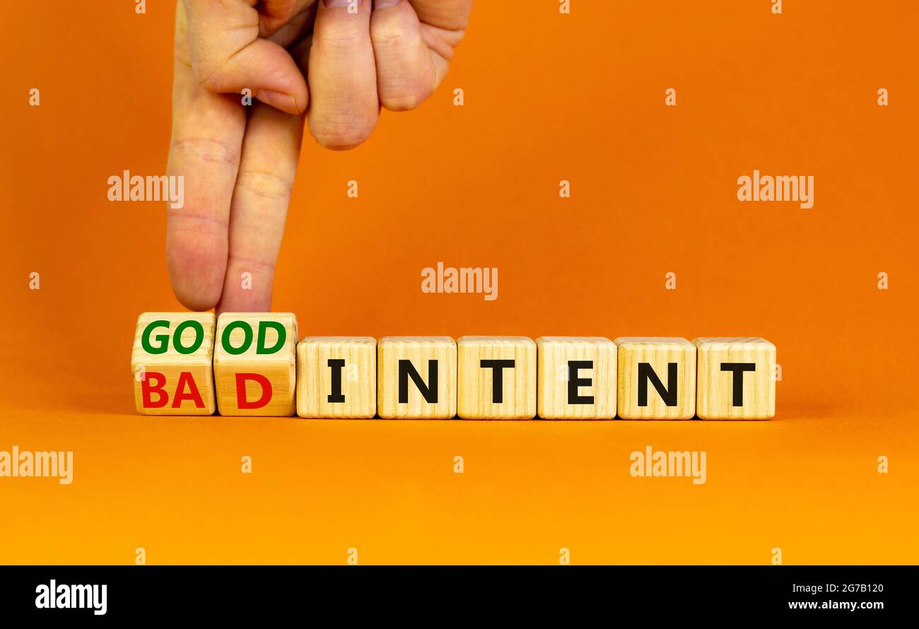 Good or bad intent symbol. Businessman turns wooden cubes and changes ...