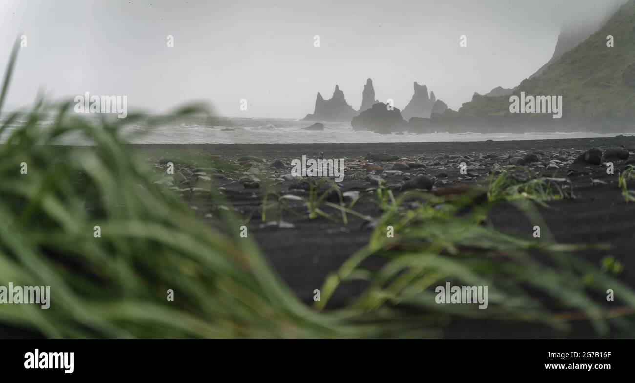 Reynisfjara black sand beach and Reynisdrangar basalt sea stacks on ...