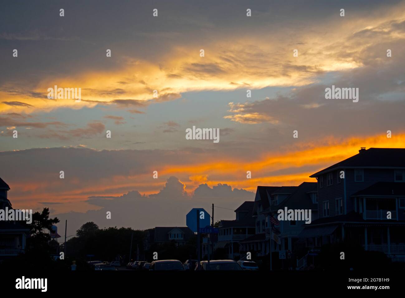 Colorful sunset in a sky lined with cumulo-nimbus clouds viewed from ...