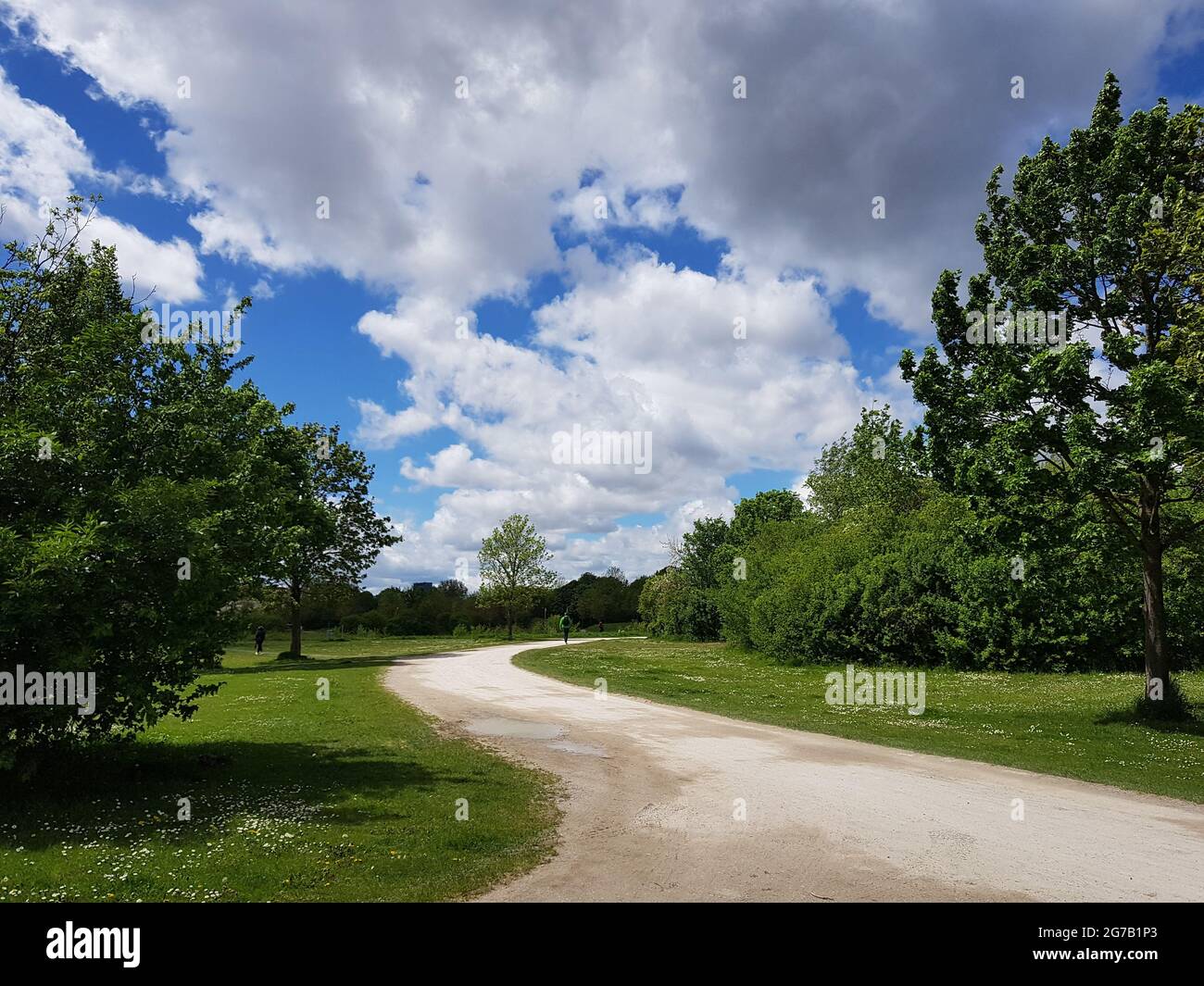 Blue sky with clouds and walking path Stock Photo - Alamy