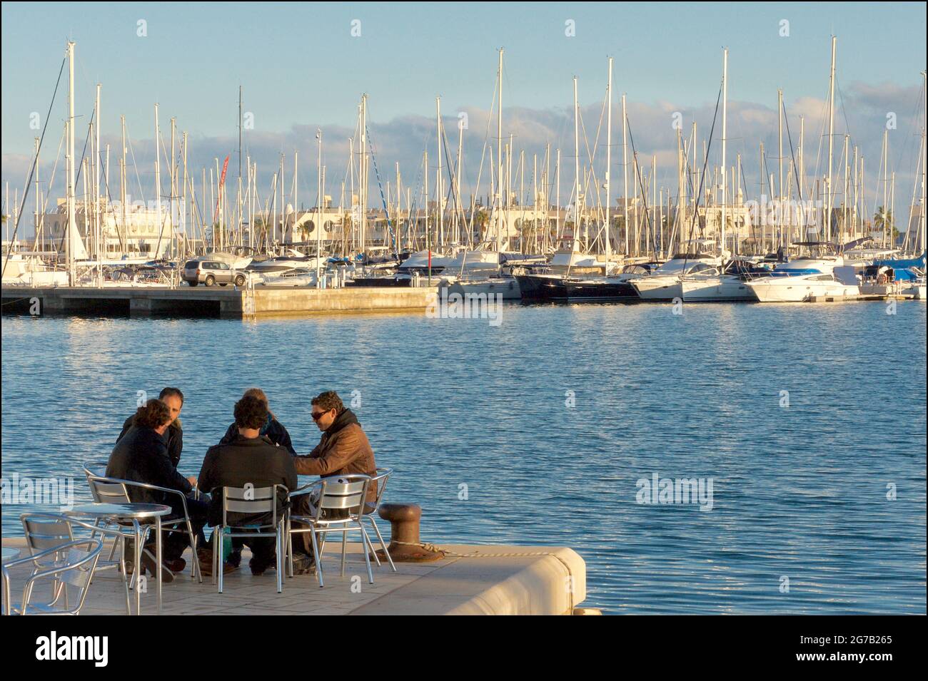 Boats and Yachts in the Marina of Alicante. Friends sitting on chairs ...