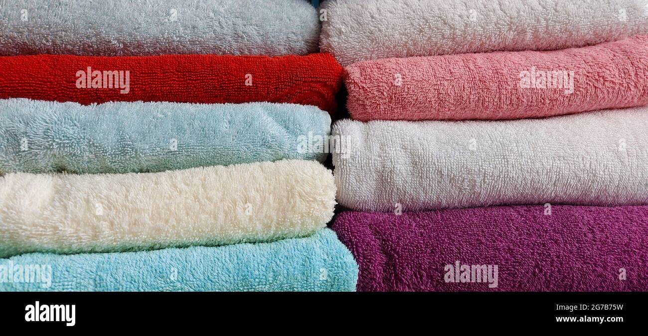 Multi-colored cotton terry towels are stacked Stock Photo - Alamy