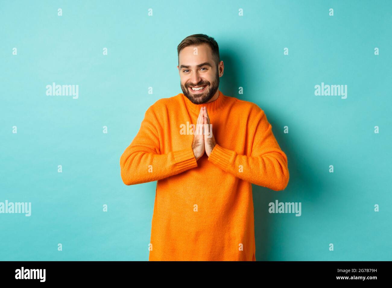 Happy man saying thank you, holding hands in pray, looking grateful and ...
